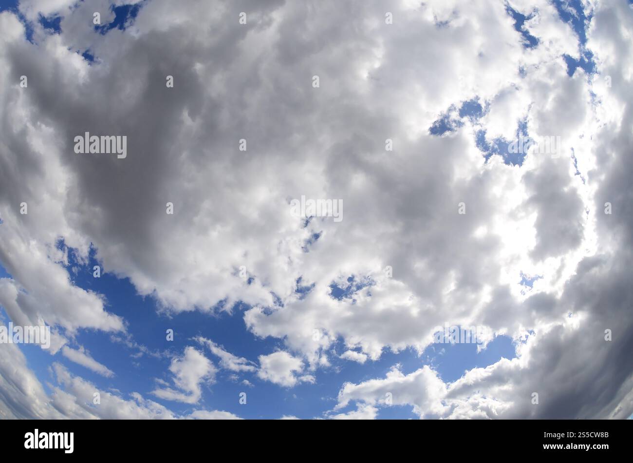 A blue sky with lots of white clouds of different sizes. Fisheye photo ...