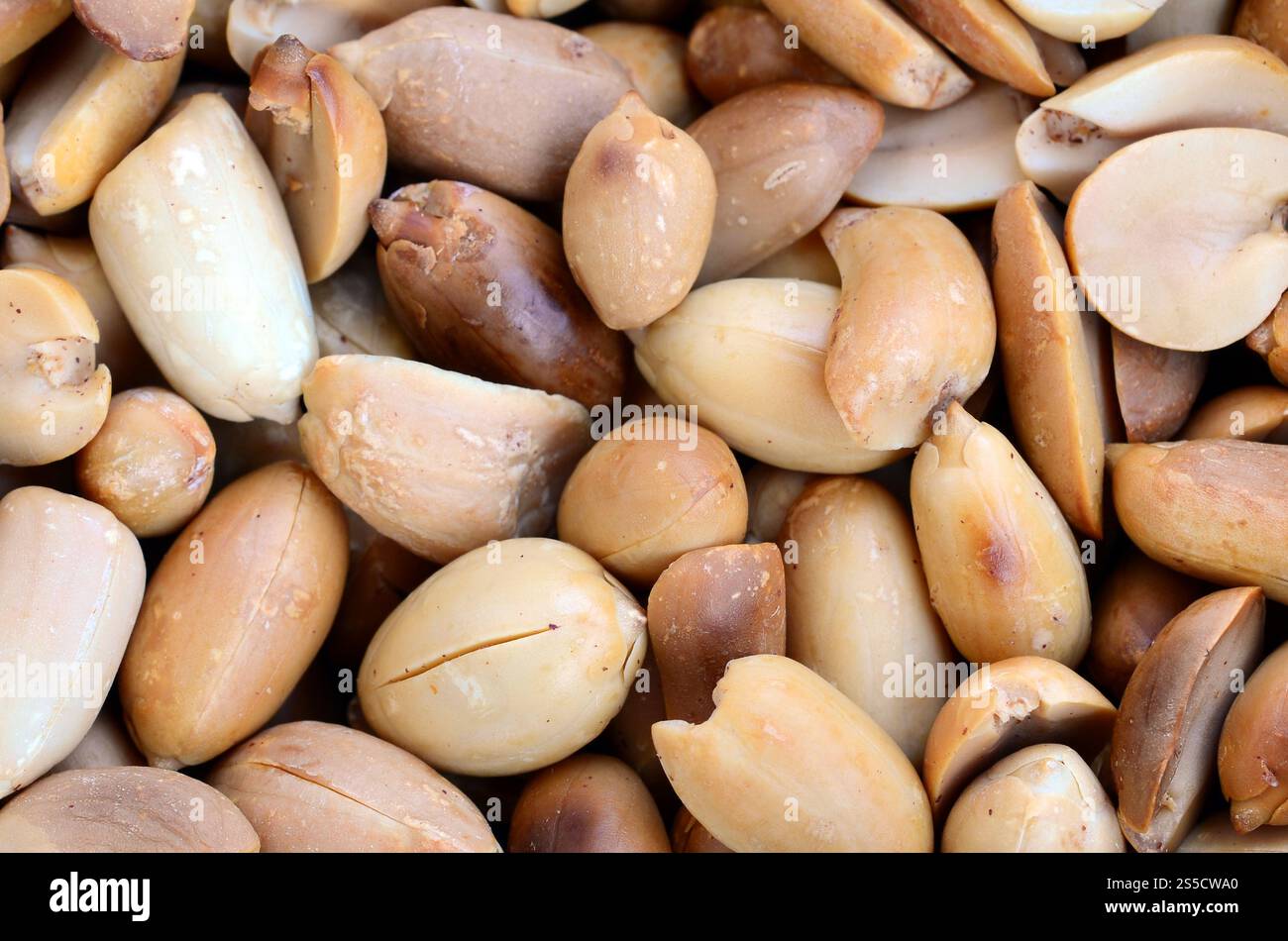 Peanut. A lot of small yellow nuts without peel. Background texture ...