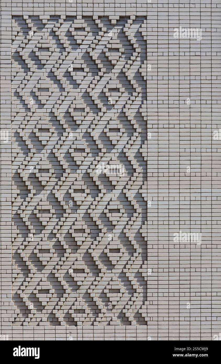 A pattern made of white bricks in the form of diamond shapes. Decoration of the walls during the ...