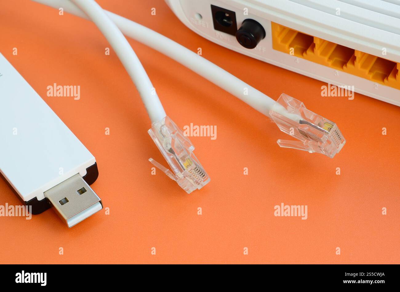 Internet Router Portable Usb Wi Fi Adapter And Internet Cable Plugs Lie On A Bright Orange