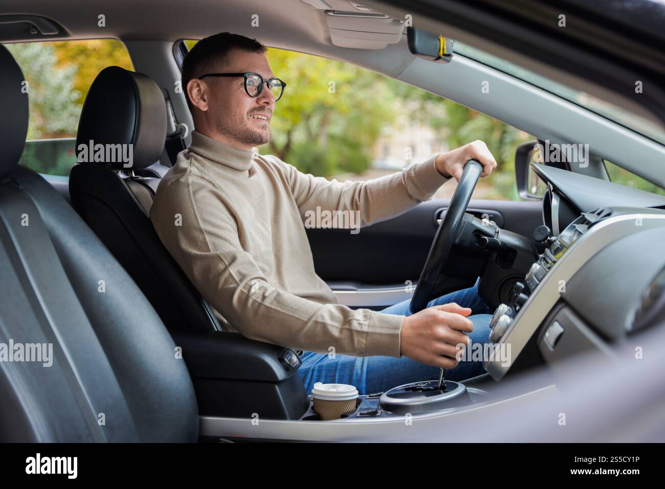 Man driving modern car, view through window Stock Photo - Alamy