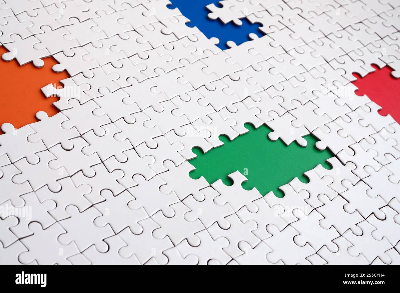 Close-up texture of a white jigsaw puzzle in assembled condition with ...