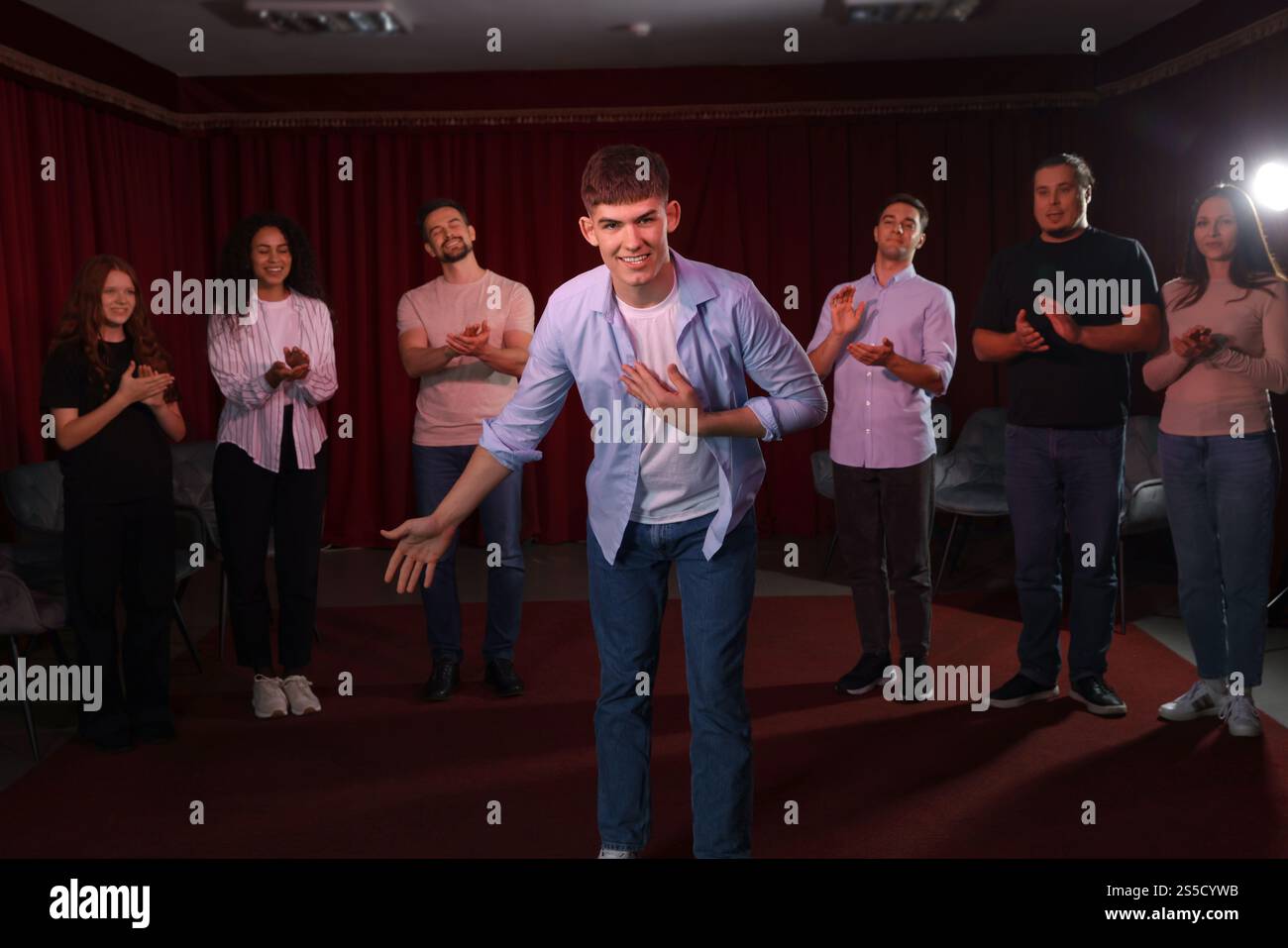 Professional actors bowing on stage in theatre Stock Photo - Alamy