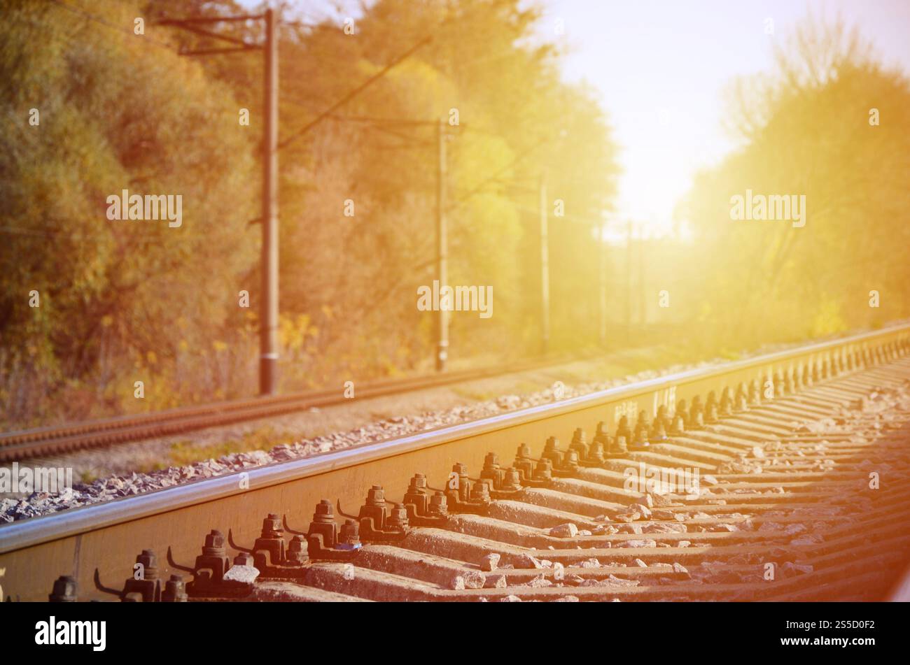 Autumn industrial landscape. Railway receding into the distance among ...