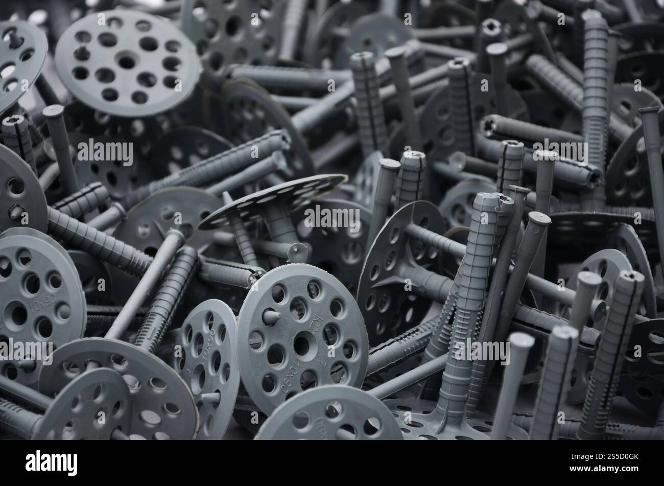 Background pattern of many gray plastic dowels (fastening) for thermal ...