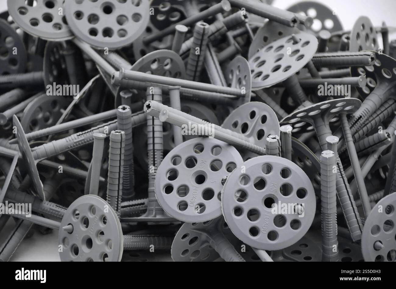 Background pattern of many gray plastic dowels fastening for thermal ...