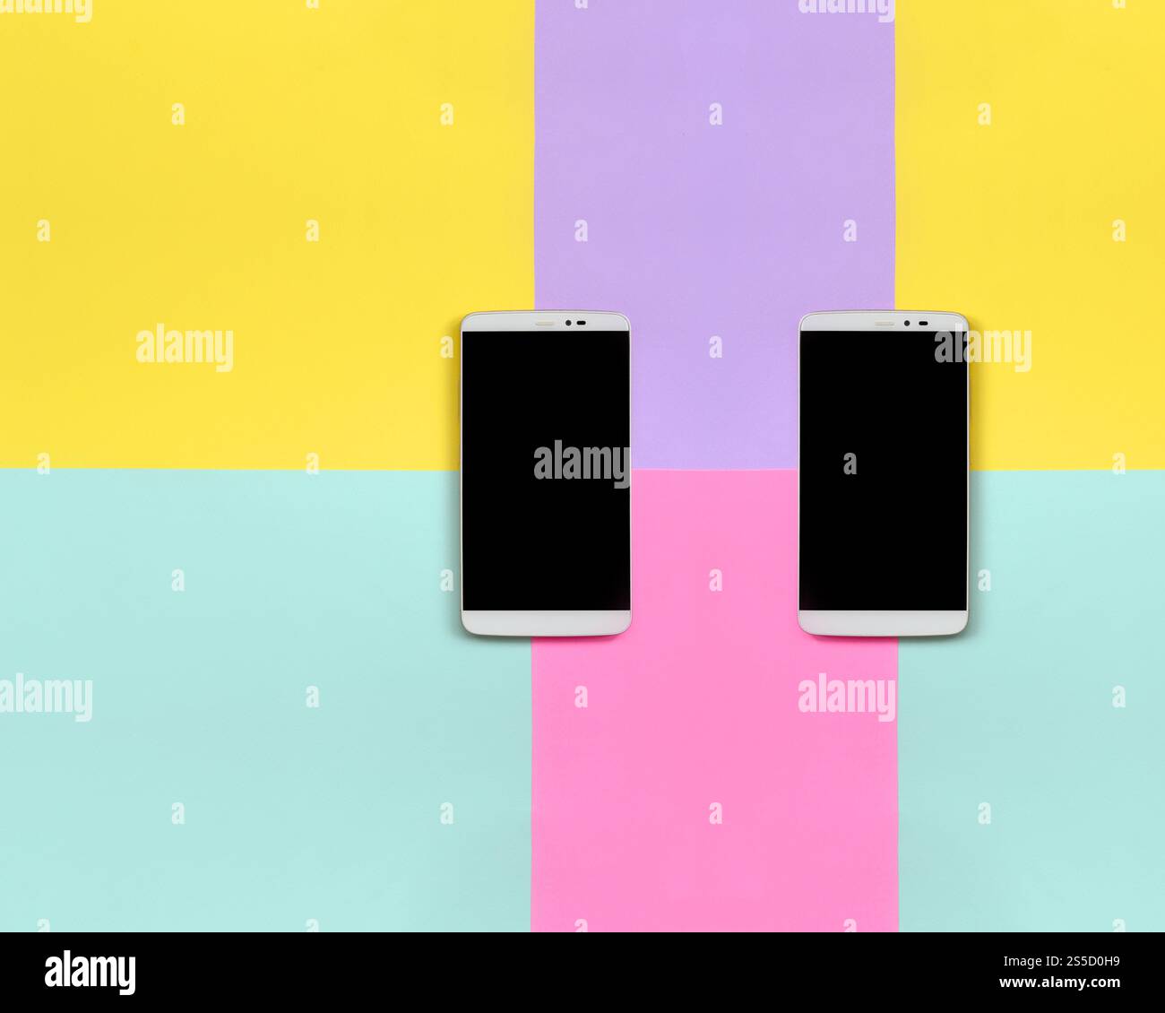 Two modern smartphones with black screens on texture background of ...