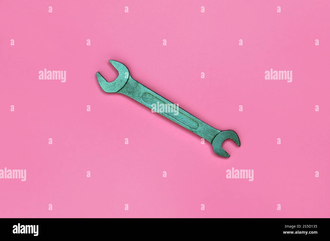 Metallic spanner lie on texture background of fashion pastel pink color ...