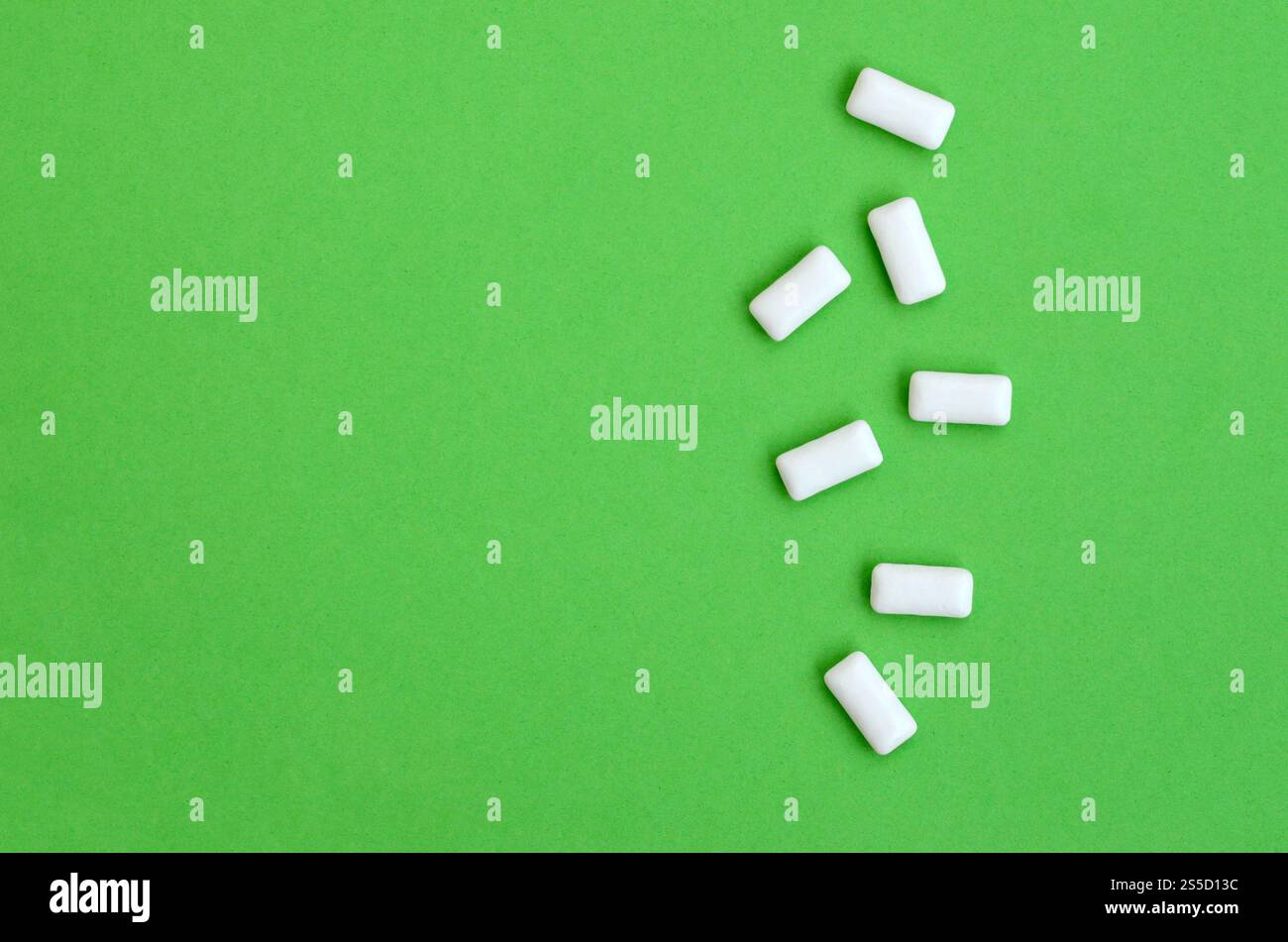 A few chewing gums lie on texture background of fashion pastel green ...