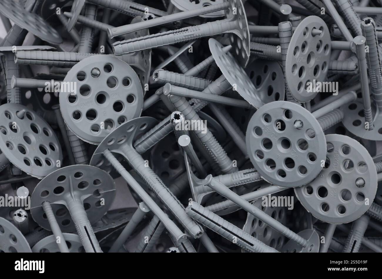 Background pattern of many gray plastic dowels (fastening) for thermal ...