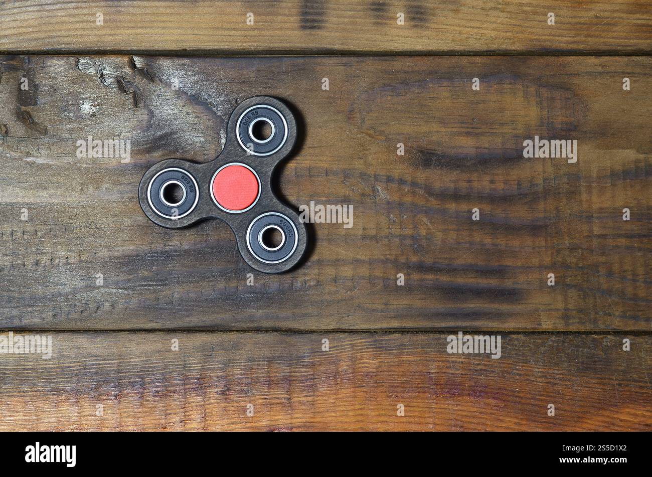 Popular finger spinner device. Modern fidget spinning toy on bearings ...