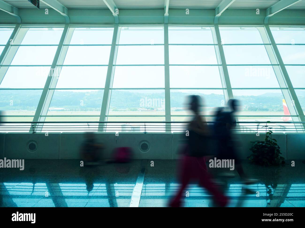 Passengers walking in an airport terminal. Travel background ...