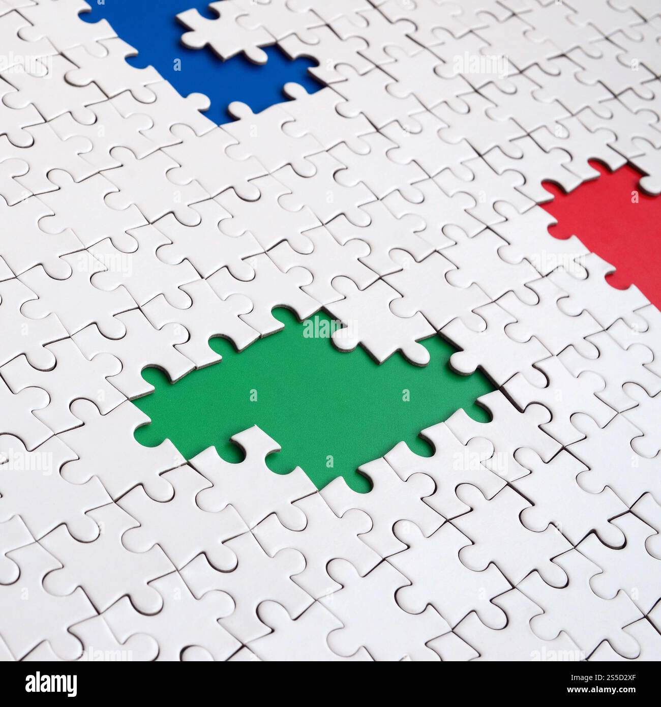 Close-up texture of a white jigsaw puzzle in assembled condition with ...