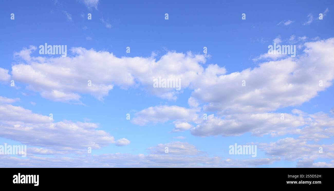 A blue sky with lots of white clouds of different sizes Stock Photo - Alamy