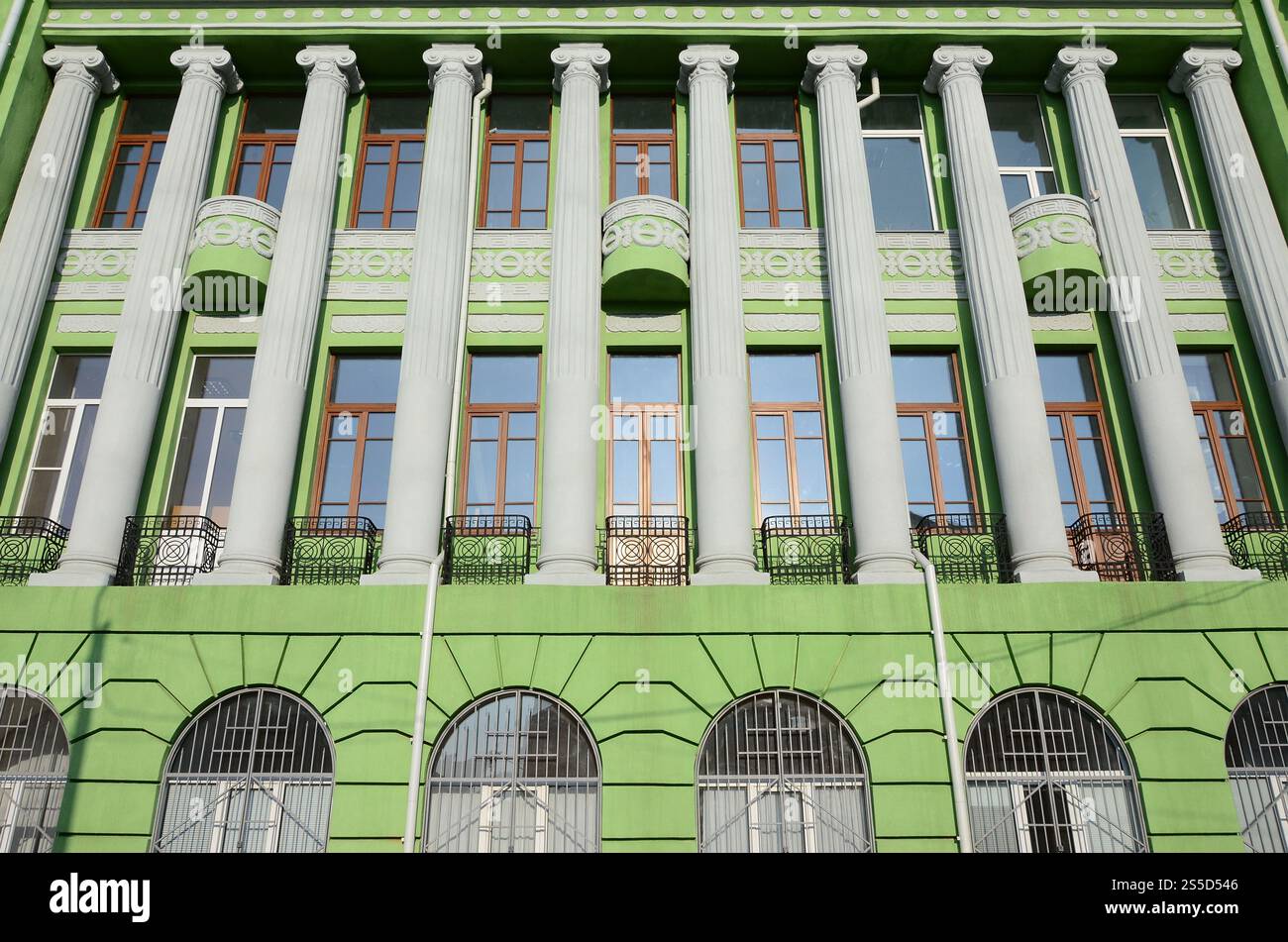 Restored old multi-storey building with antique columns, painted in ...