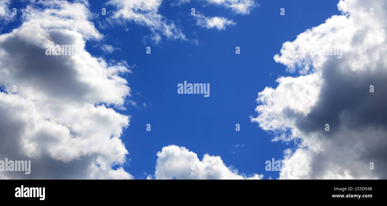 The blue sky with a lot of white clouds of different sizes, forming a ...