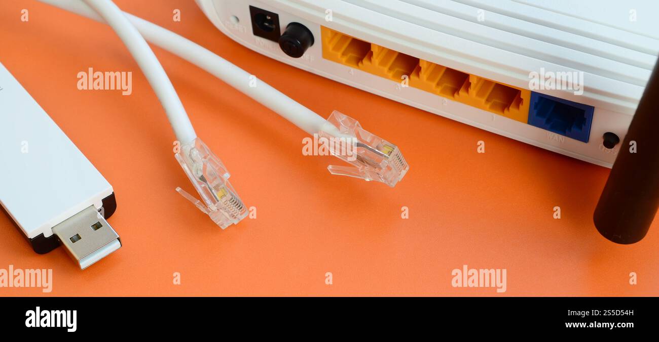 Internet Router Portable Usb Wi Fi Adapter And Internet Cable Plugs Lie On A Bright Orange