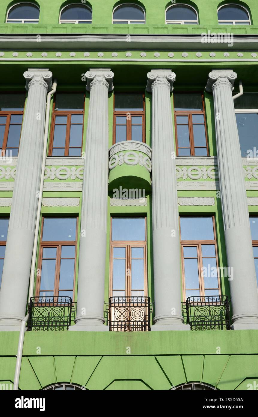 Restored old multi-storey building with antique columns, painted in ...