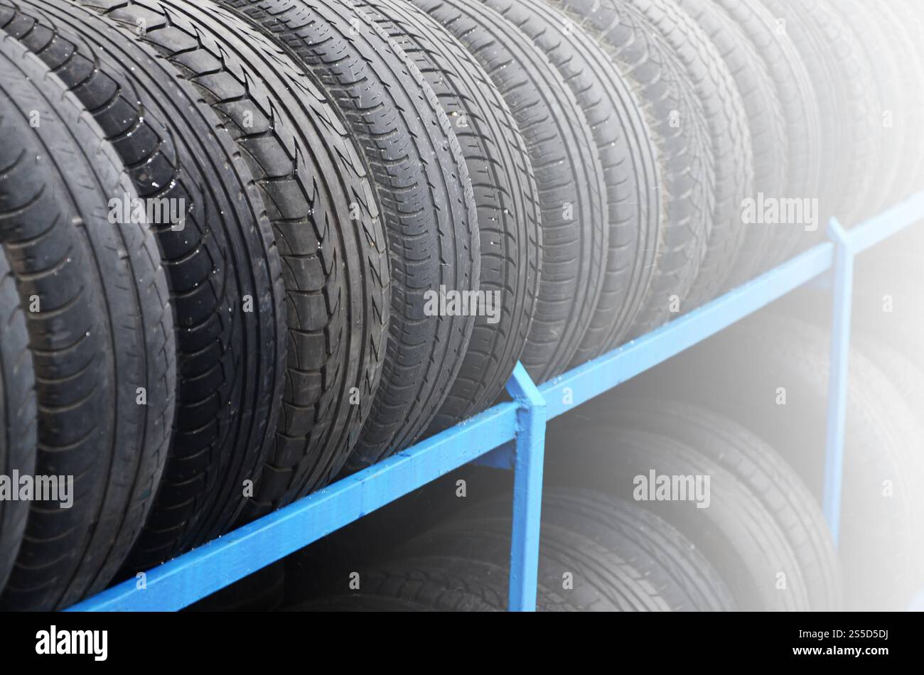 Rack with variety of car tires in automobile store. Many black tires ...