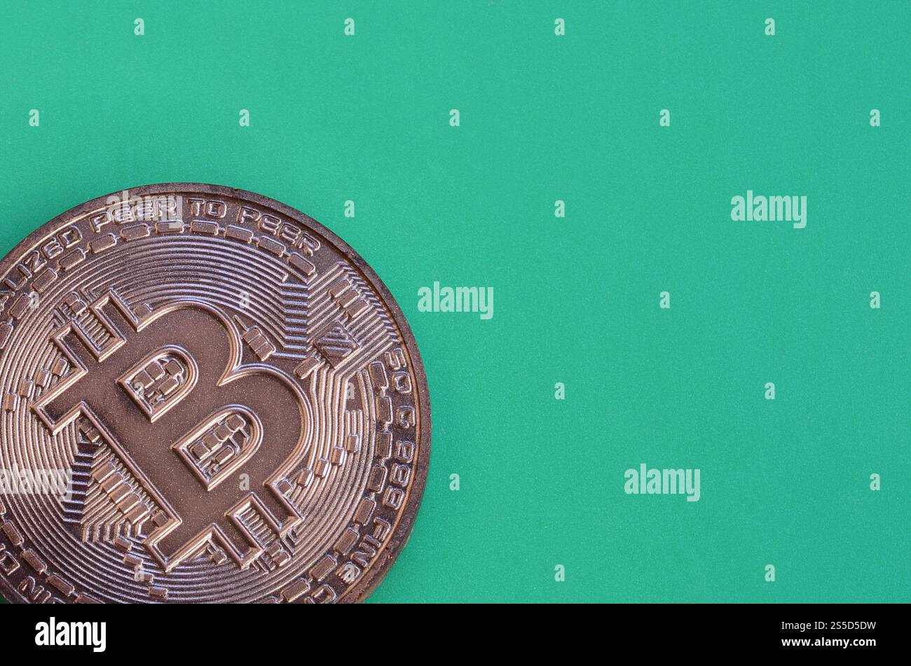 Chocolate product in the form of physical bitcoin lies on a green ...