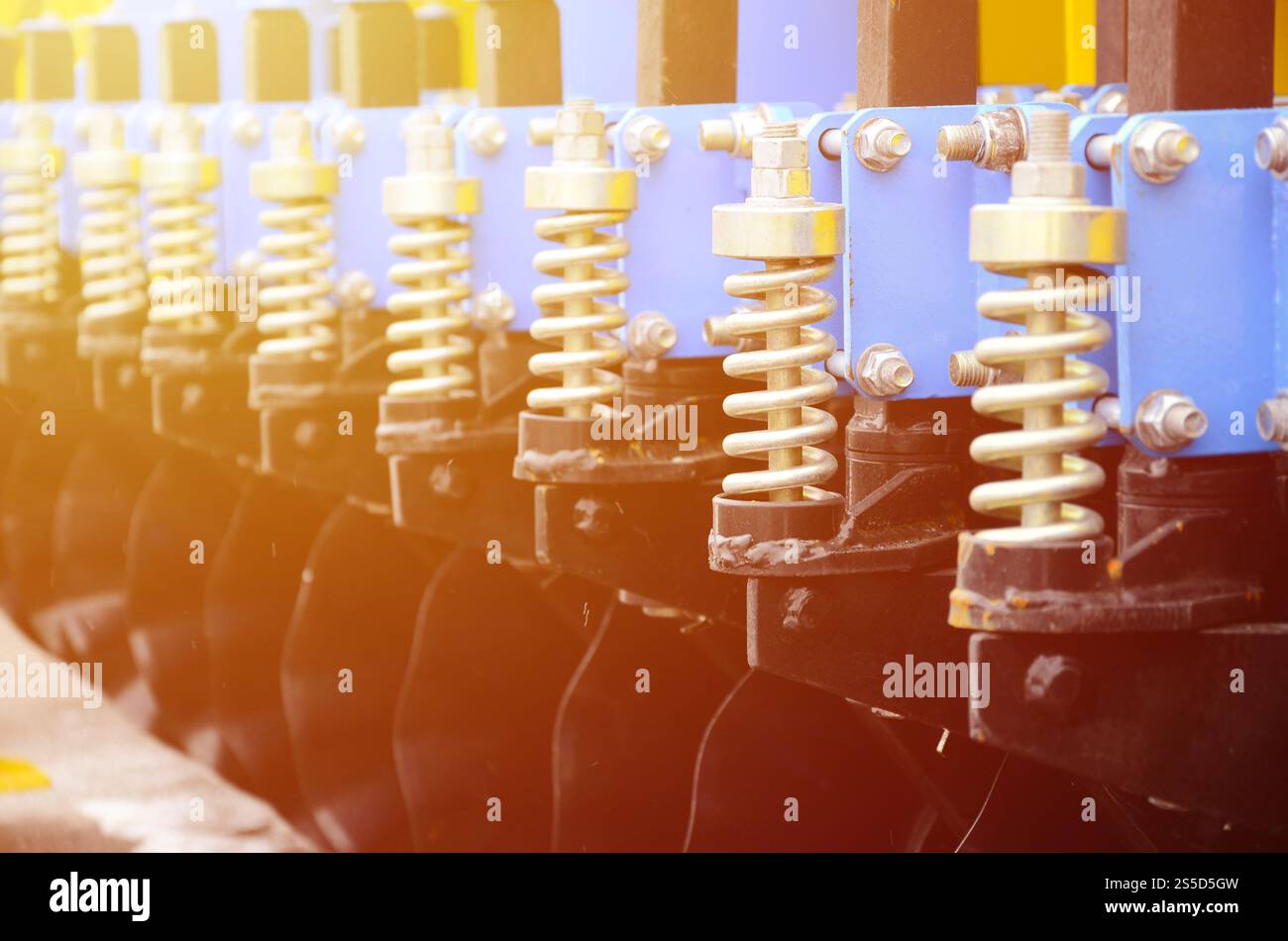 Spring system of agricultural seeder close up Stock Photo - Alamy