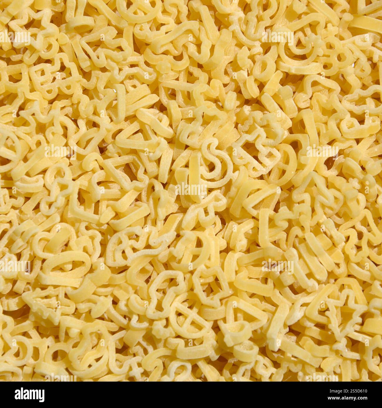 Texture of a lot of curly raw yellow pasta Stock Photo - Alamy