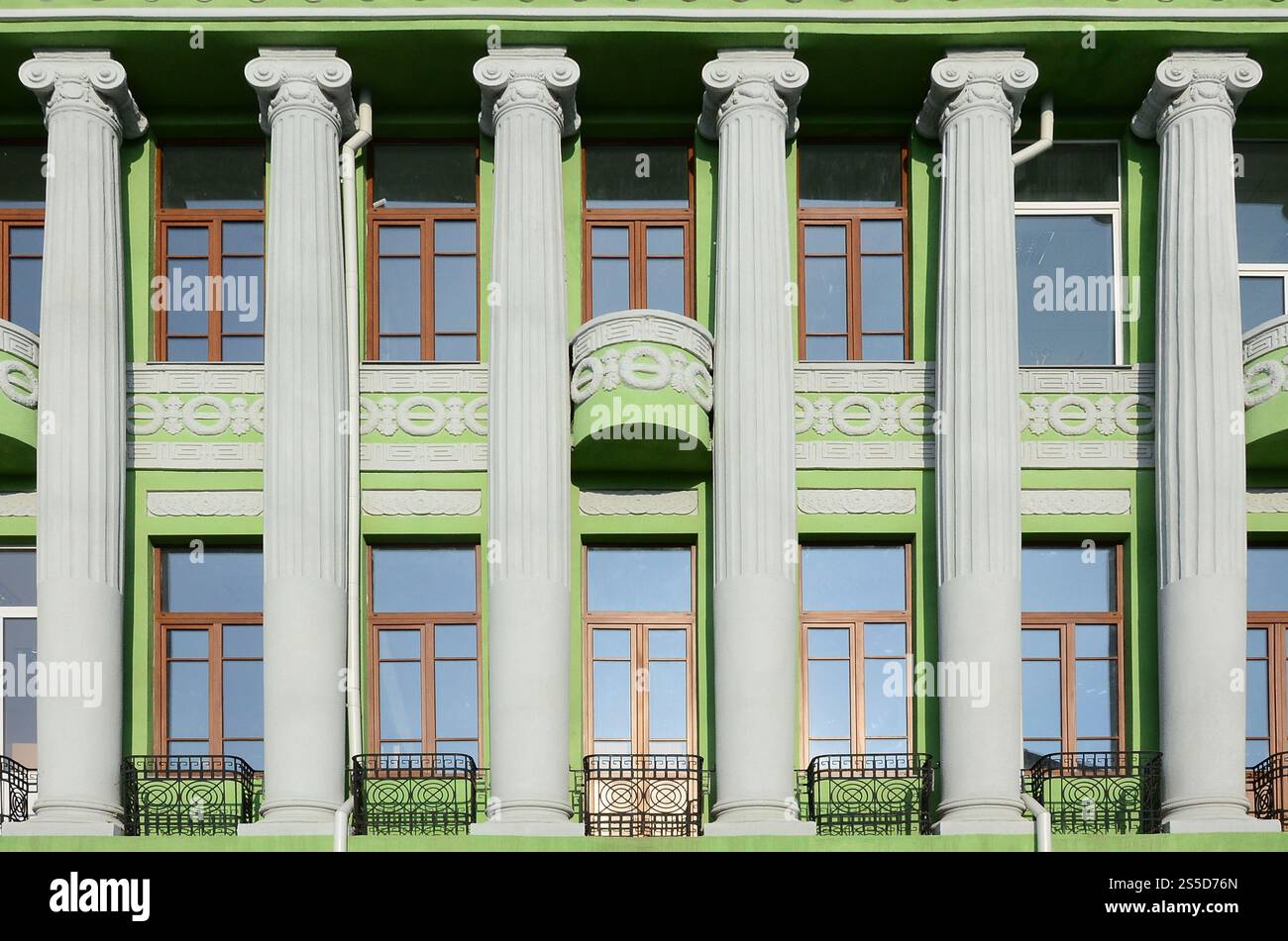 Restored old multi-storey building with antique columns, painted in ...