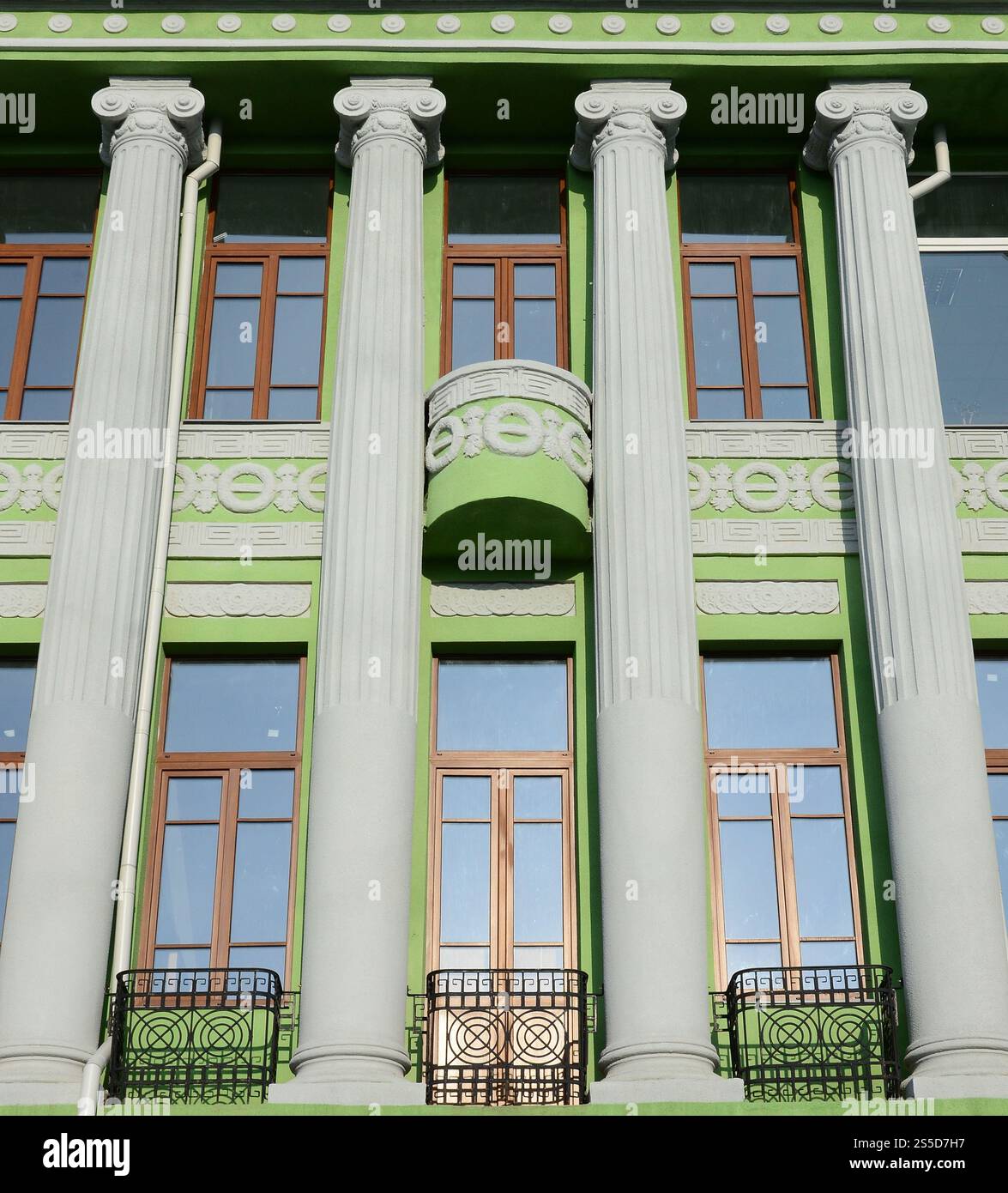Restored old multi-storey building with antique columns, painted in ...