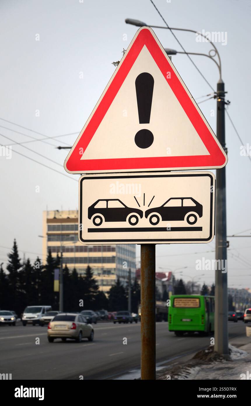 High risk of collision. A road sign with an exclamation point and two ...