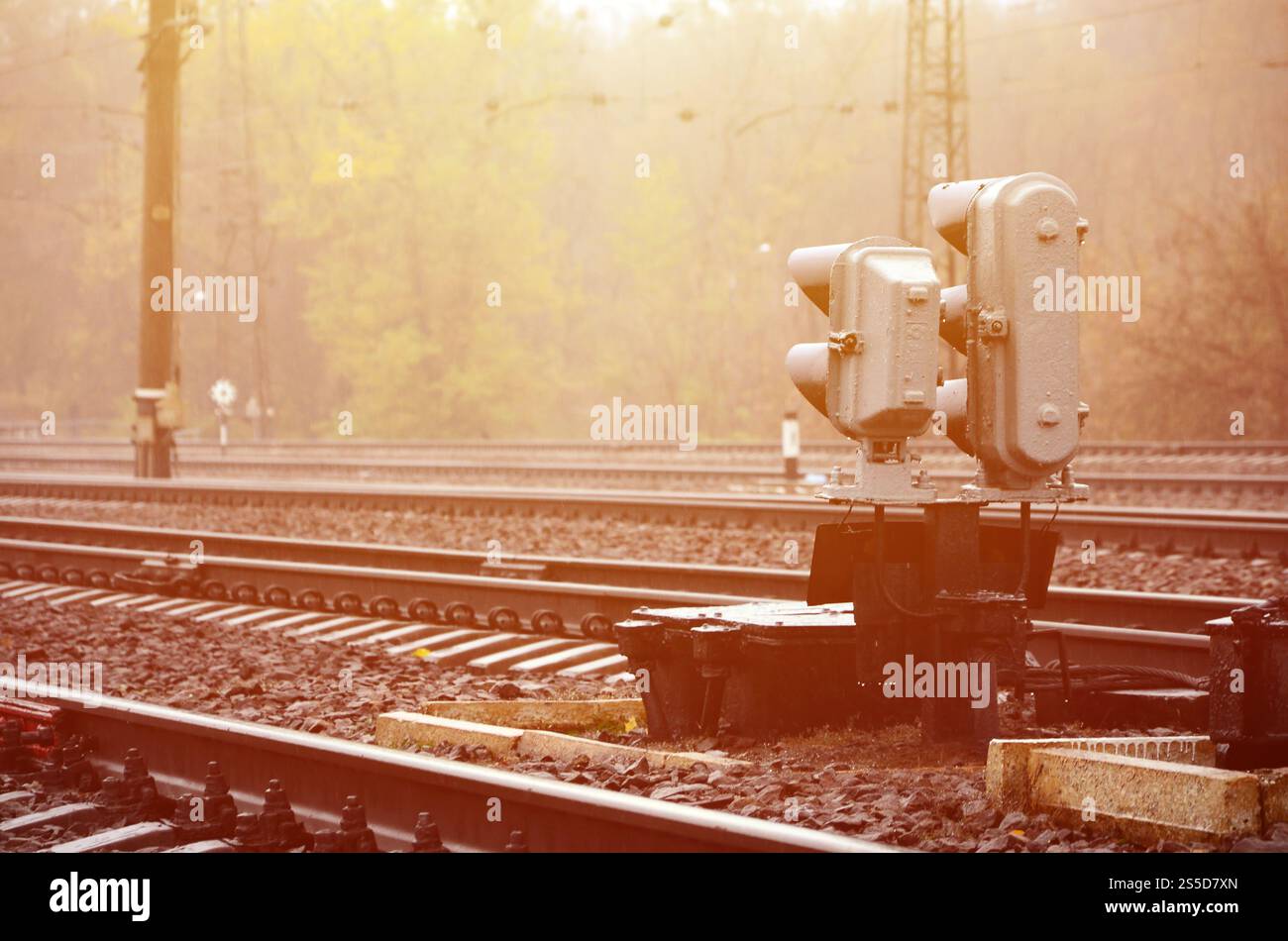 Photo of a fragment of a railway track with a small traffic light in ...