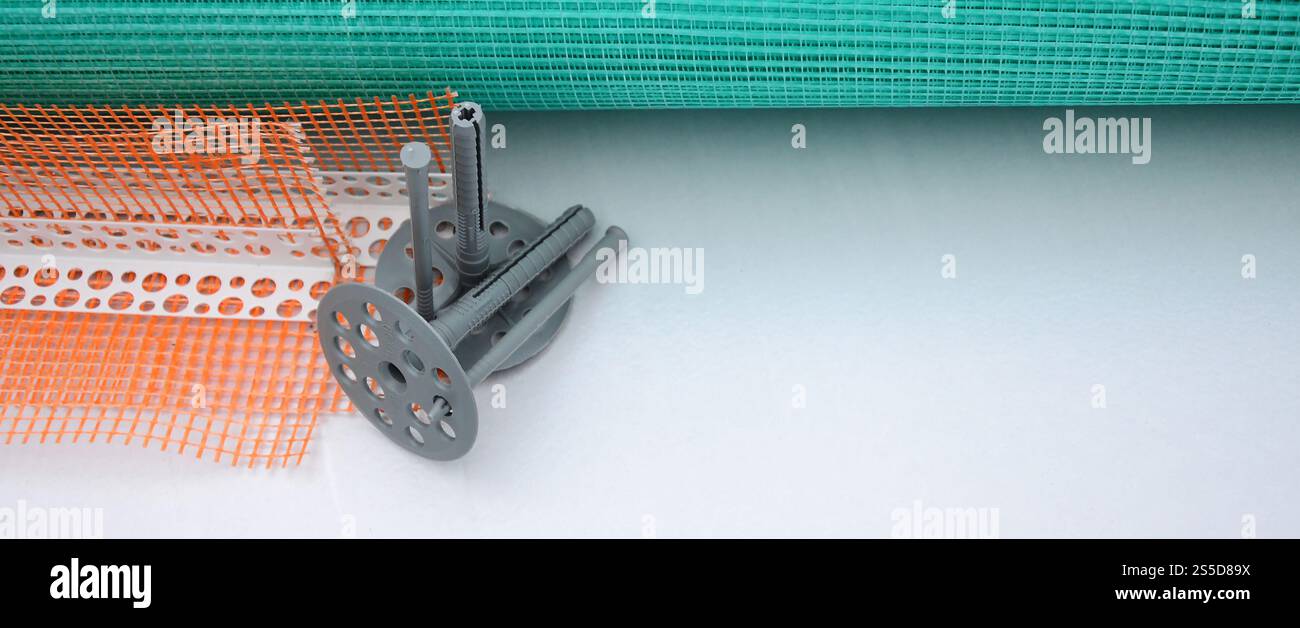 A set of construction items for the insulation of walls. Plastic dowels ...
