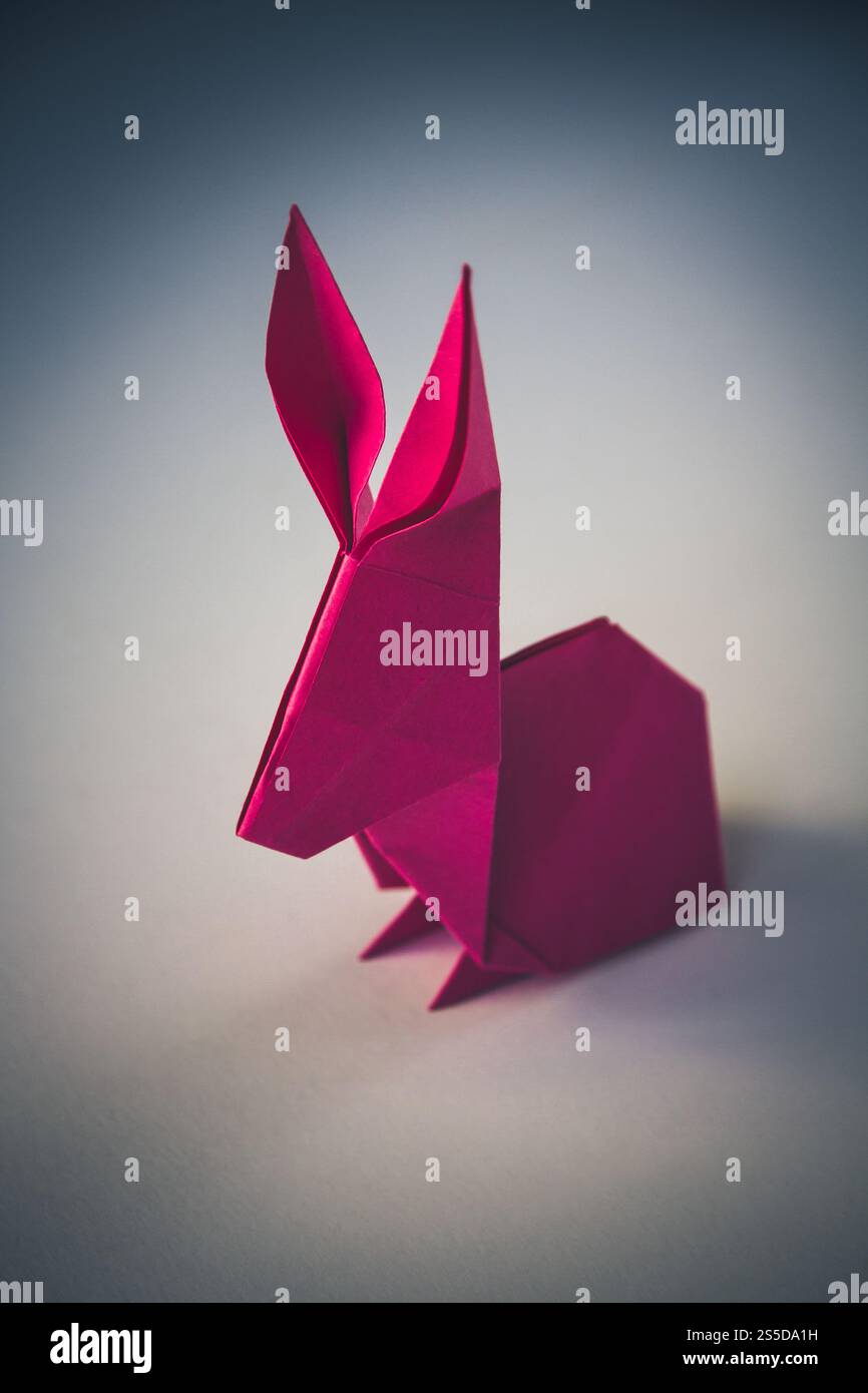 Pink paper rabbit origami isolated on a blank background. Pink paper ...