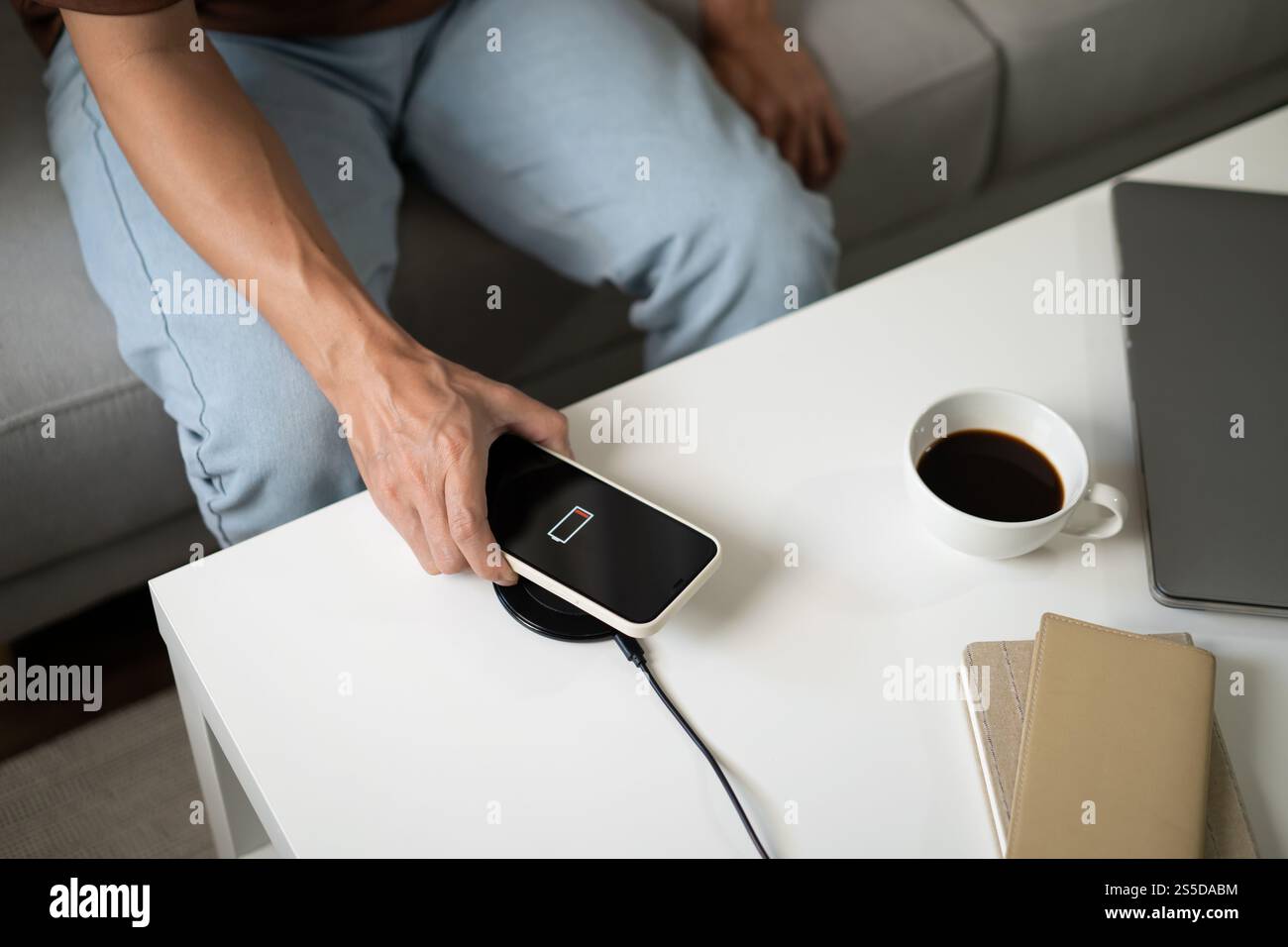Man hands Charging mobile phone battery with low battery. plugging a ...