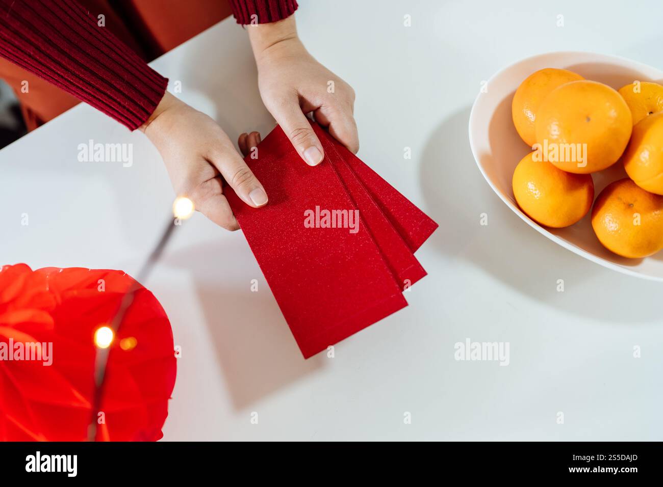 Asian Woman giving red envelope for Lunar New Year celebrations. Hand ...