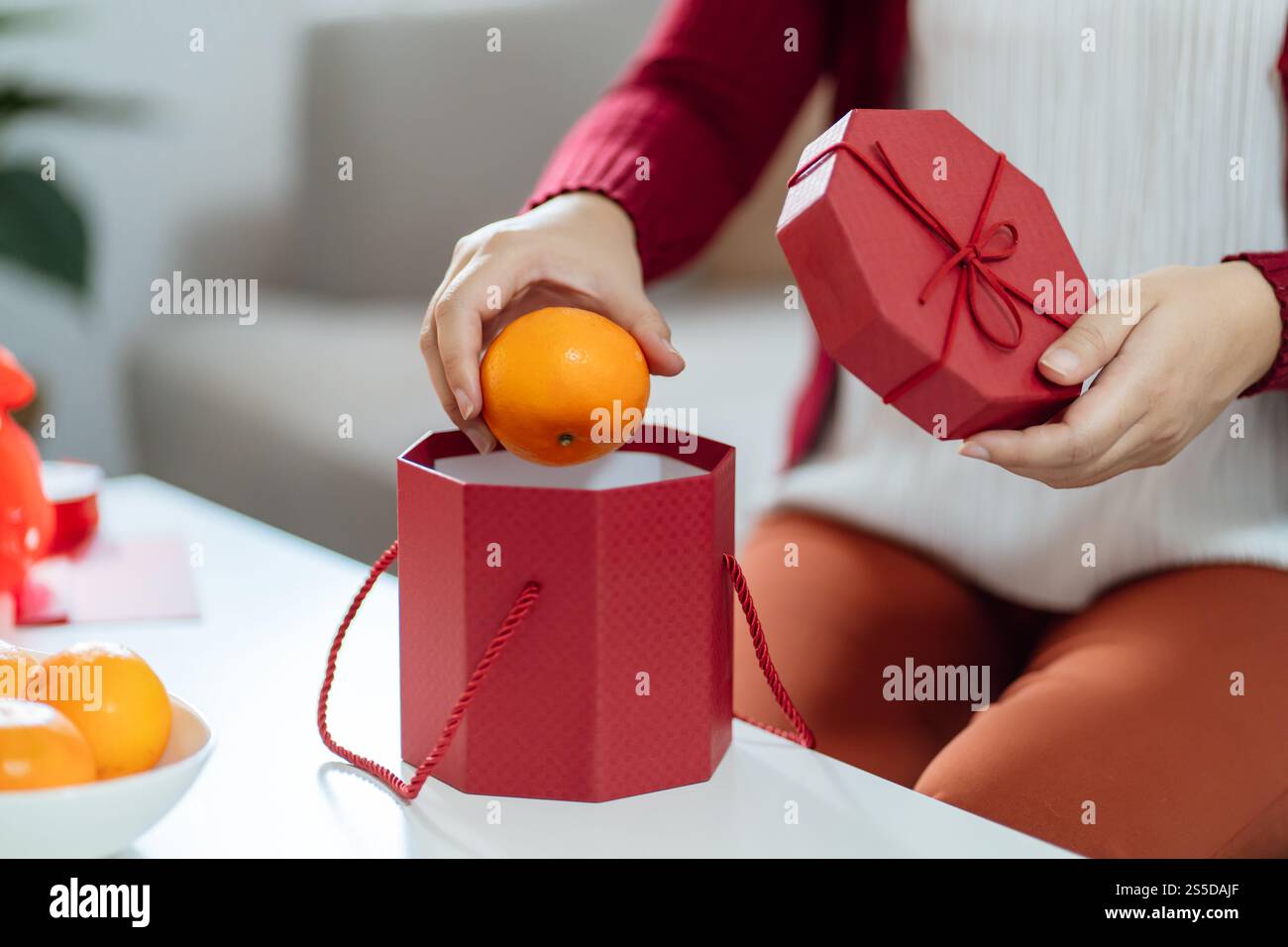 Asian Woman holding mandarin oranges with red gift box thankful present ...