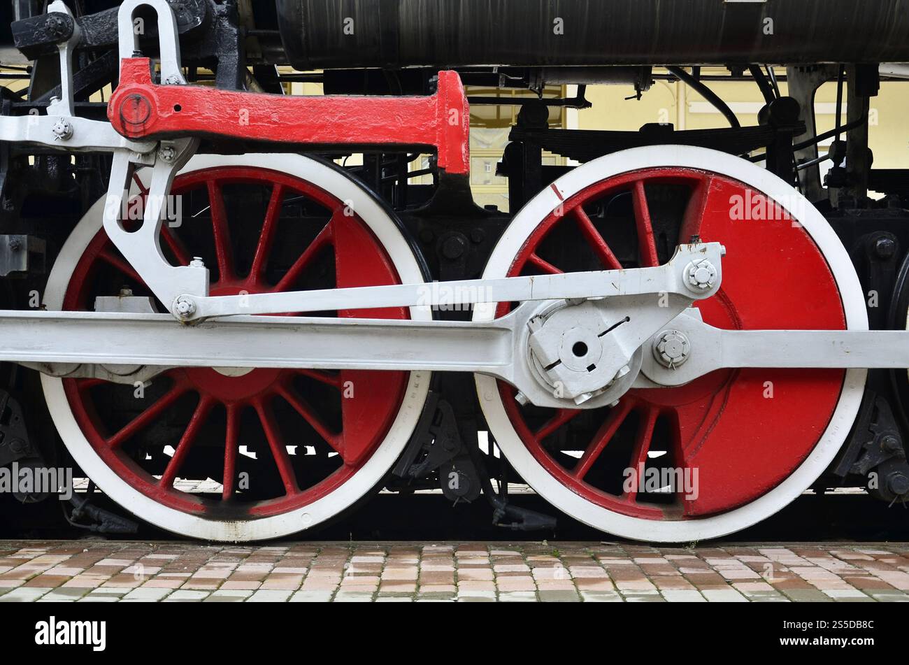 Red wheels of old USSR black steam locomotive. Wheels of an old soviet ...