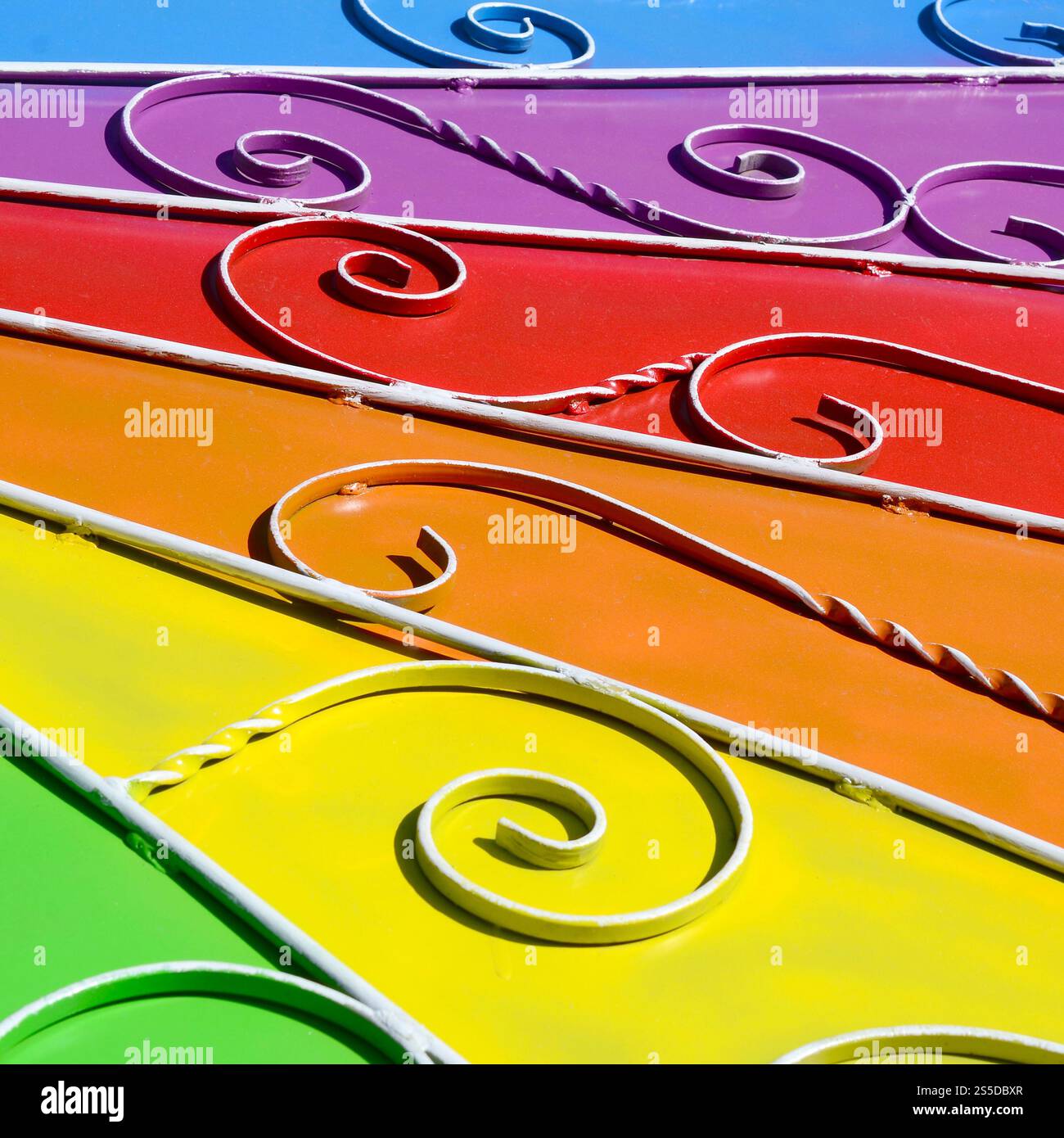 Metal texture of a piece of colored wall with a forged pattern. Rainbow ...