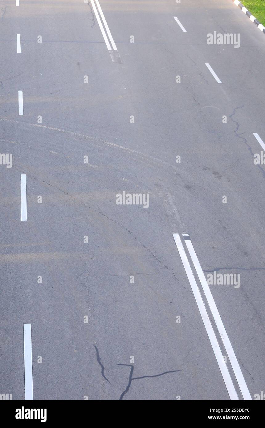 Damaged bad asphalt road with potholes. Patch repair of asphalt. Bad ...