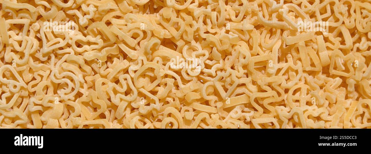 Texture of a lot of curly raw yellow pasta Stock Photo - Alamy