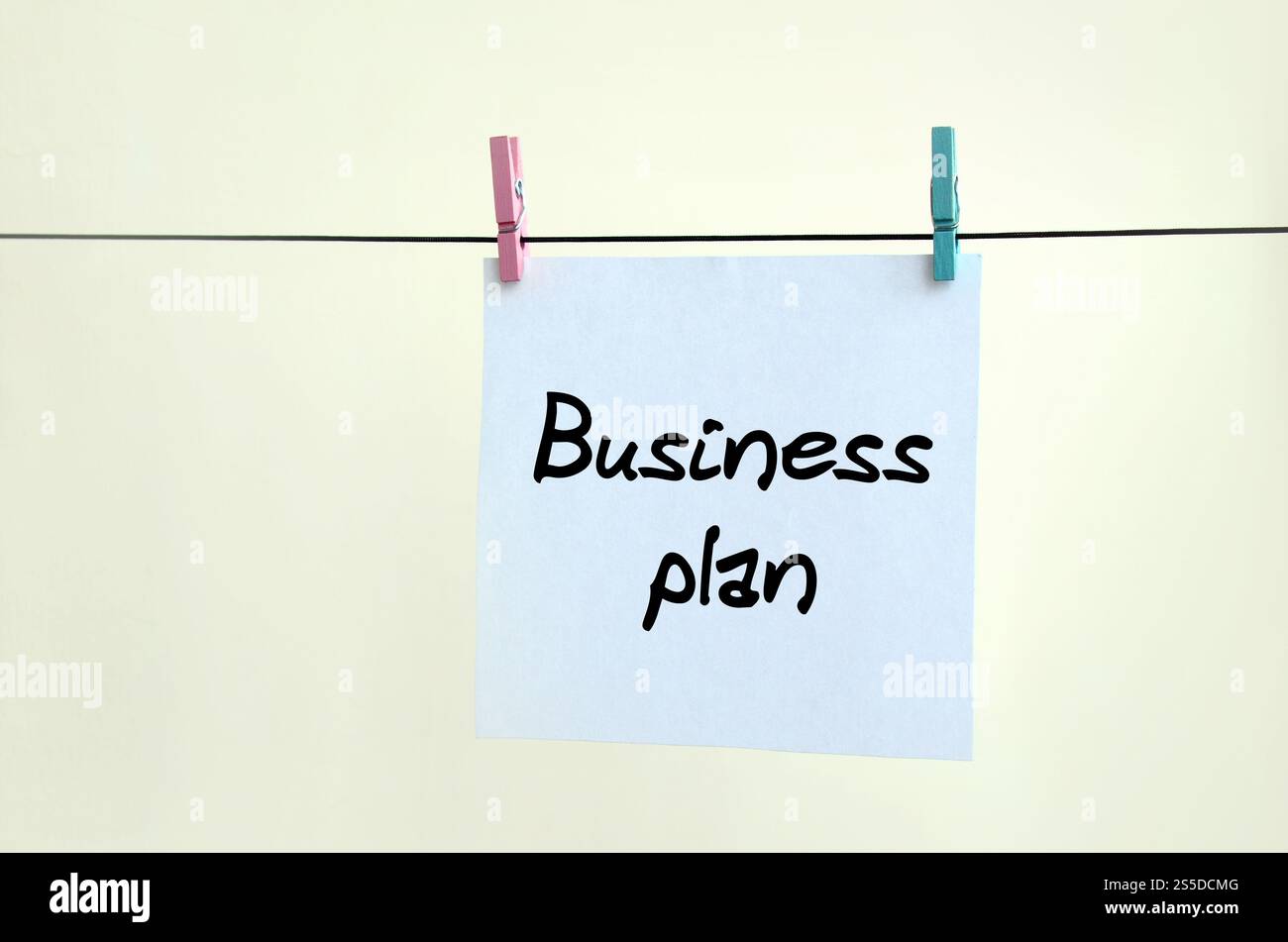 Business plan. Note is written on a white sticker that hangs with a ...
