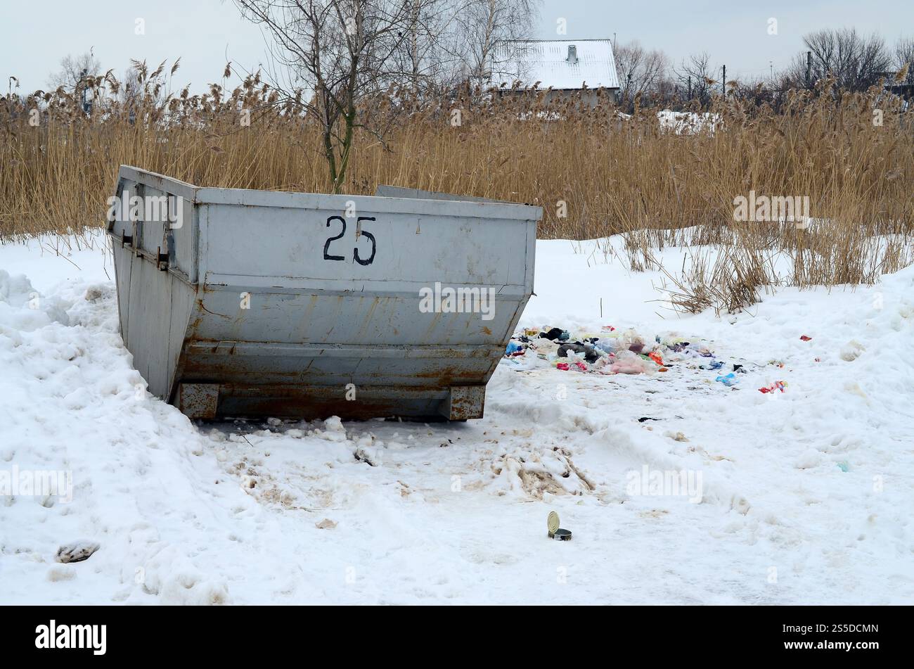 Trash bin at the side of street in winter with lip garbage container ...