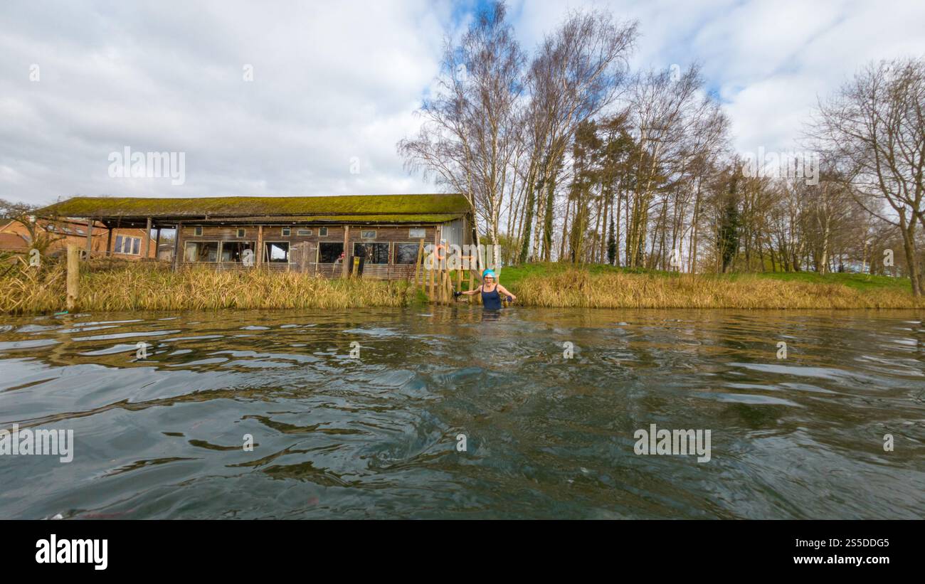 Lone female wild swimmer steps into the waters of the deserted Monet ...