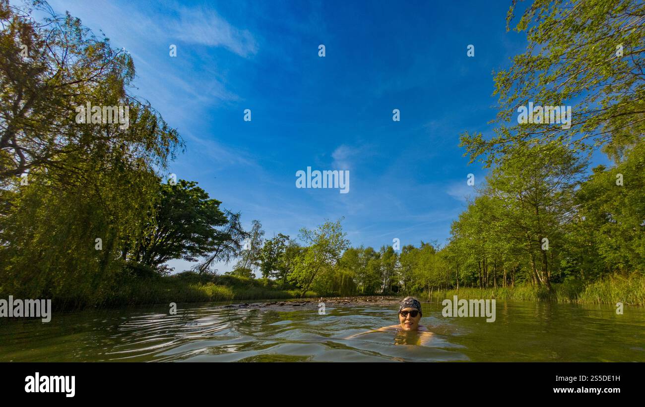 Caucasian female wild Swimming in the Monet Lake at Pool Bridge Farm ...