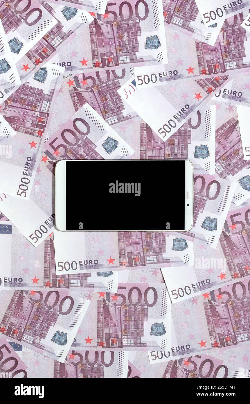 Purple 500 euro money bills and a smartphone with black screen. Copy ...