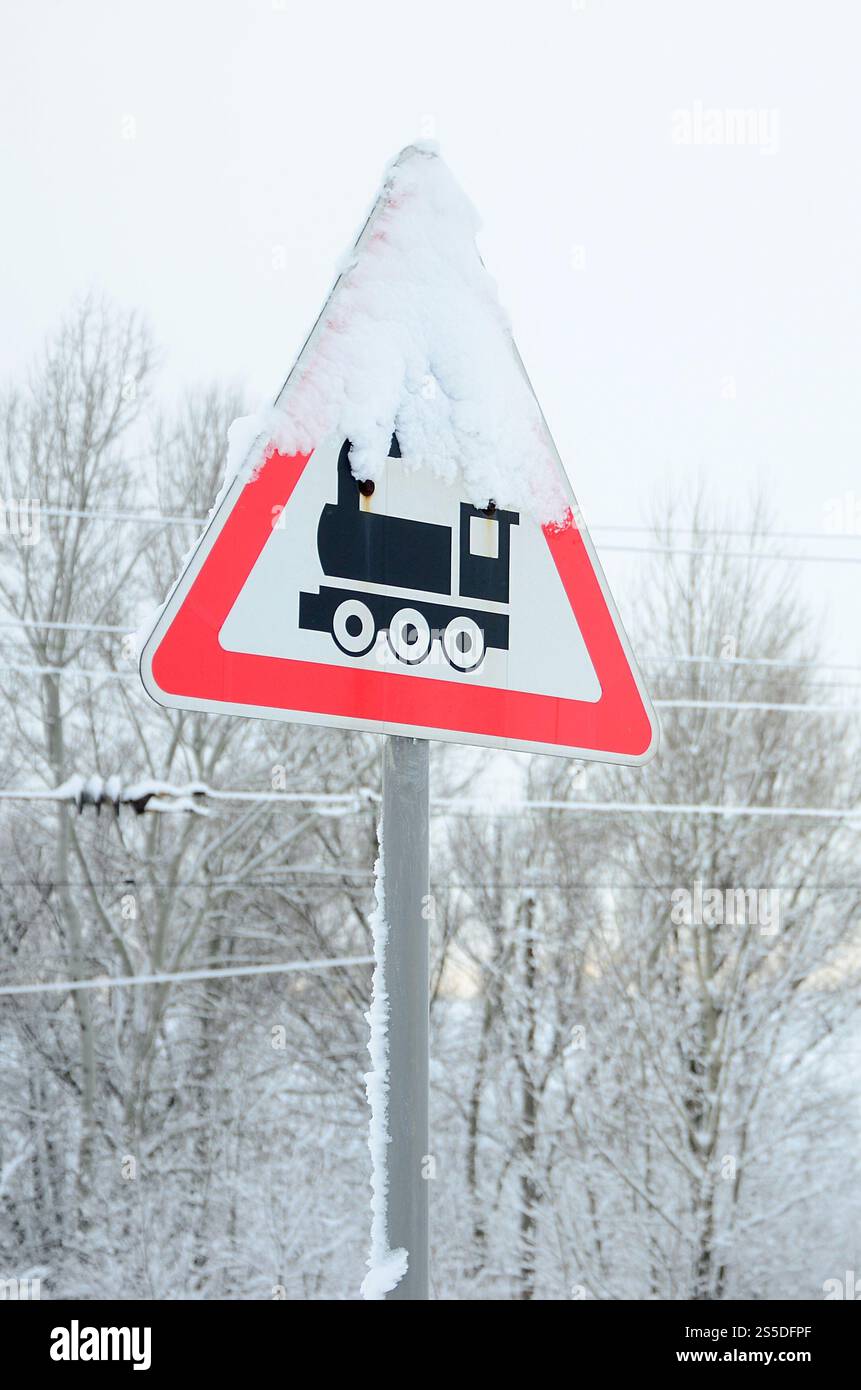 Railway crossing without barrier. A road sign depicting an old black ...