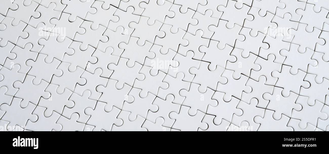Close up texture of a white jigsaw puzzle in assembled condition. Top ...