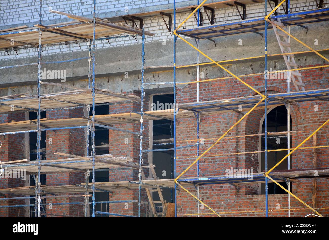 Scaffolds installed near the multi-storey brick building under ...