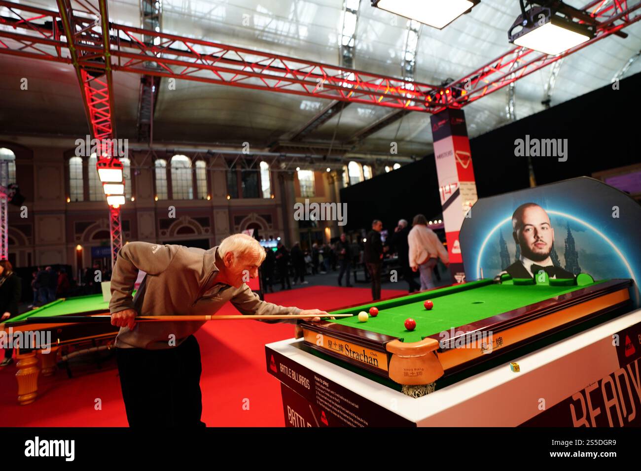 A fan playing a game of snooker in the fan zone before day three of the ...