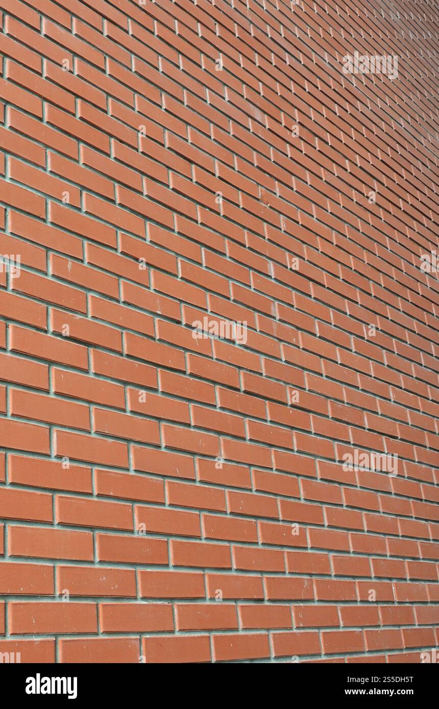The texture of a high brick wall from a many rows of red bricks ...