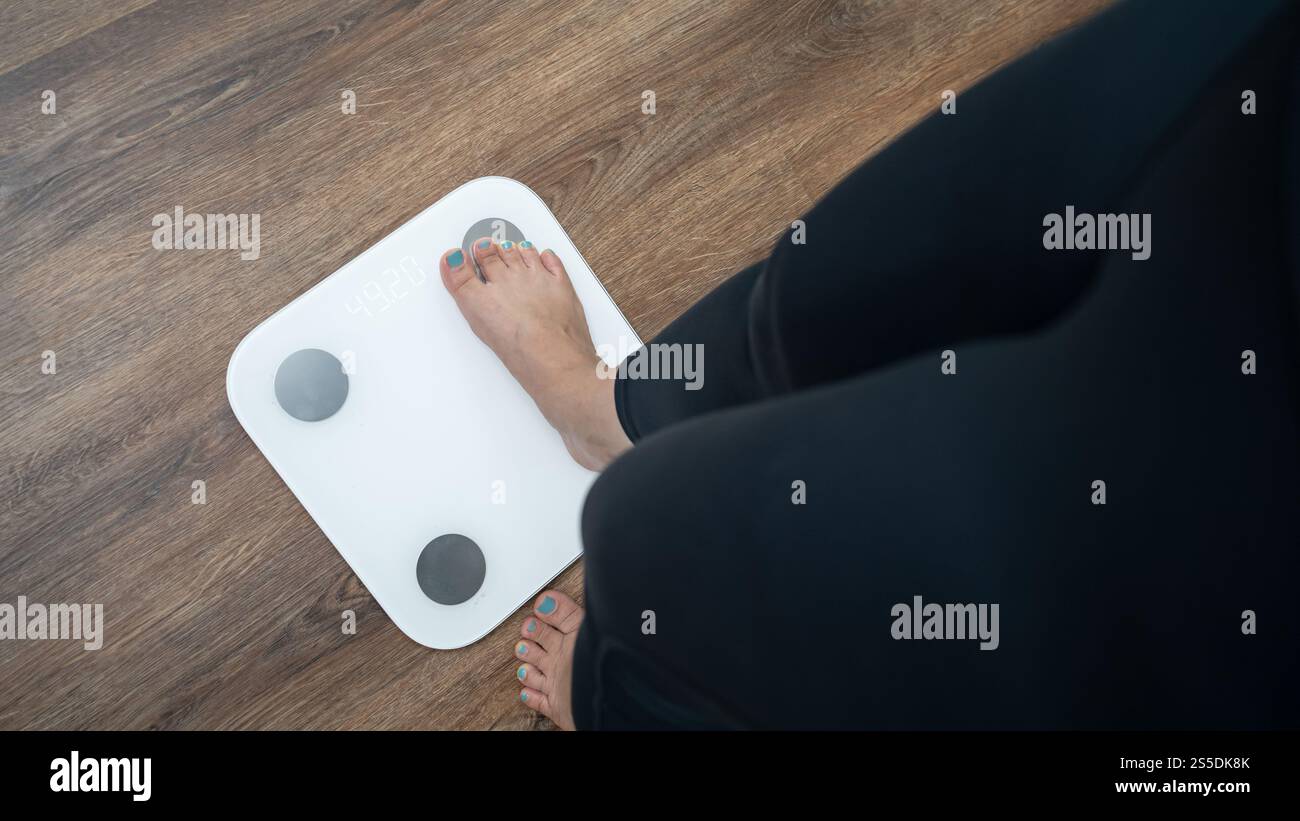 Fat diet and scale feet standing on electronic scales for weight ...